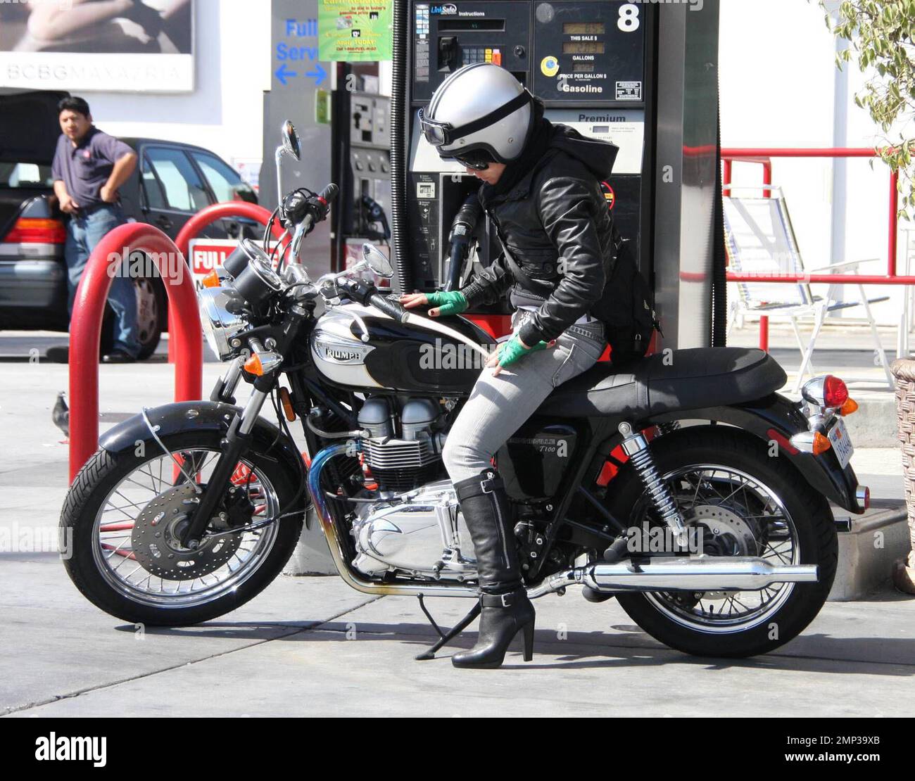 Pink stops by a gas station to fill up her Triumph Bonneville. Los ...