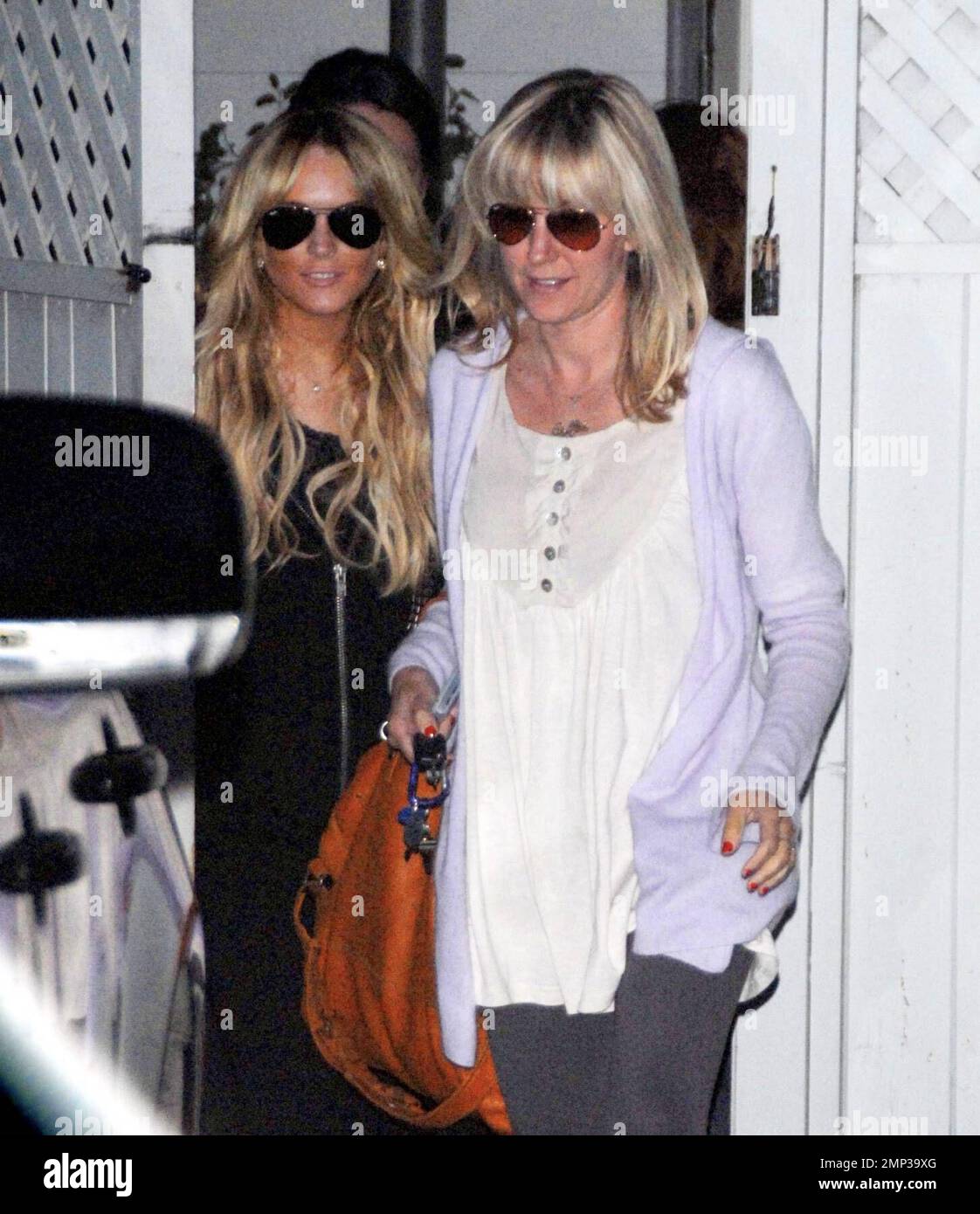 Lindsay Lohan leaves the Neil George Salon through a rear exit after ...