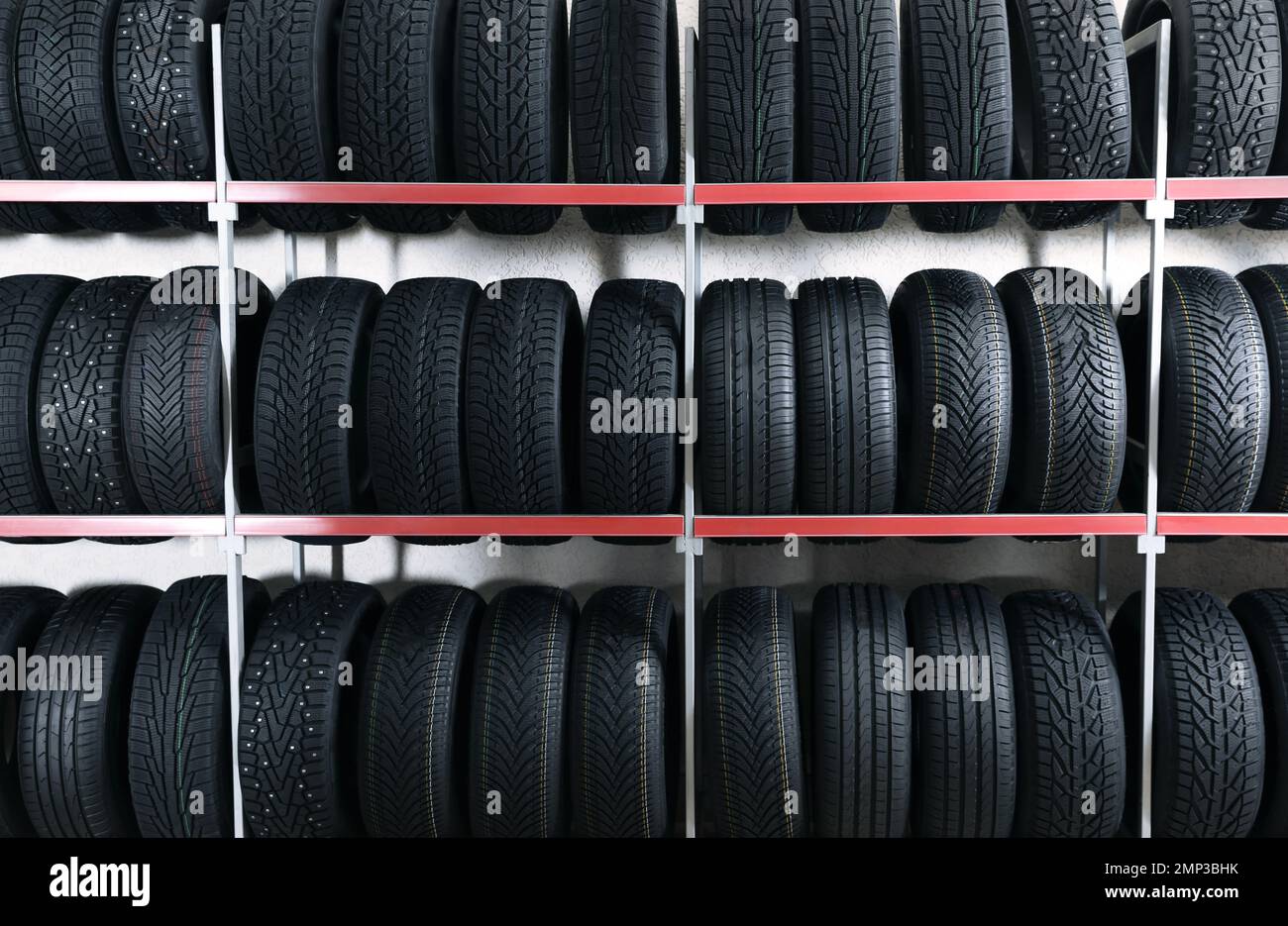 Car tires on rack in auto store Stock Photo - Alamy