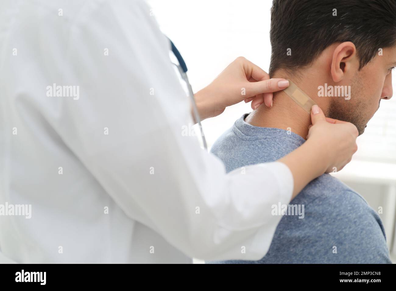 Doctor putting sticking plaster hi-res stock photography and images - Alamy