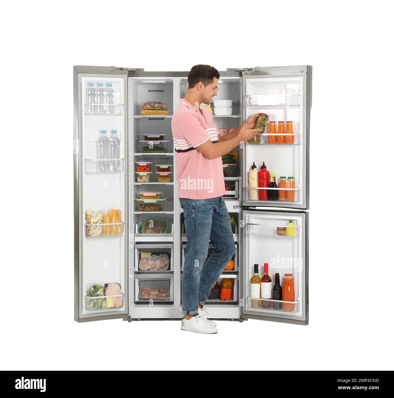Man taking pickles from refrigerator on white background Stock Photo ...