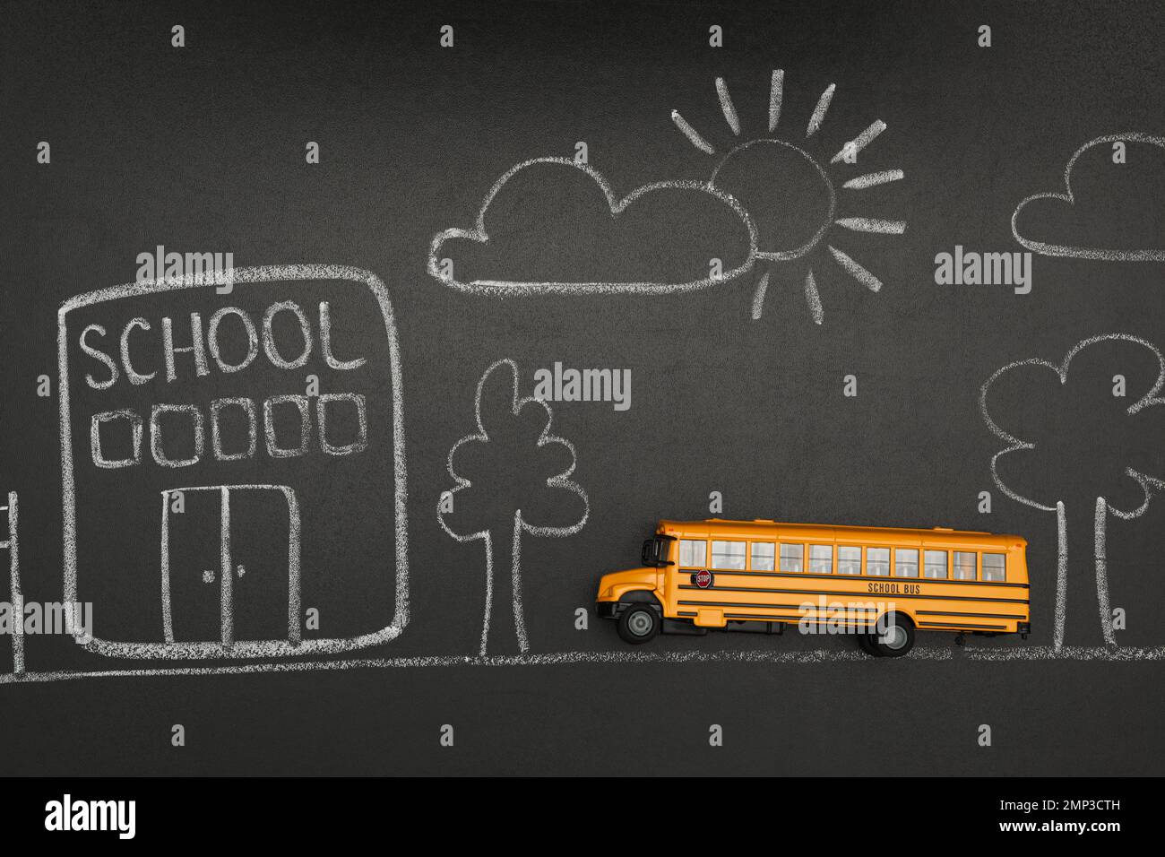 Yellow bus and drawing of school on chalkboard, top view. Transport for ...