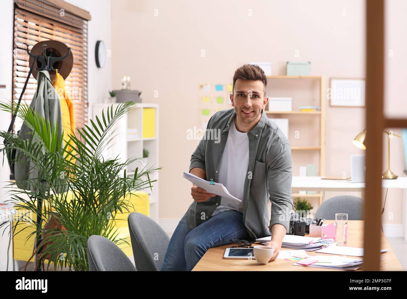 Journalist with papers at workplace in office Stock Photo - Alamy