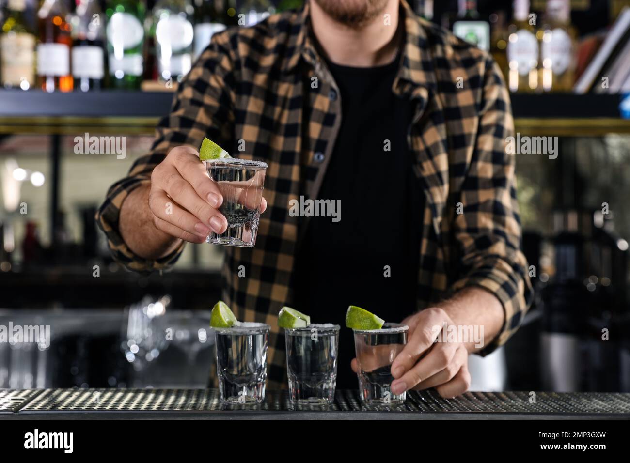 Bartender with shots of Mexican Tequila at bar counter, closeup Stock ...