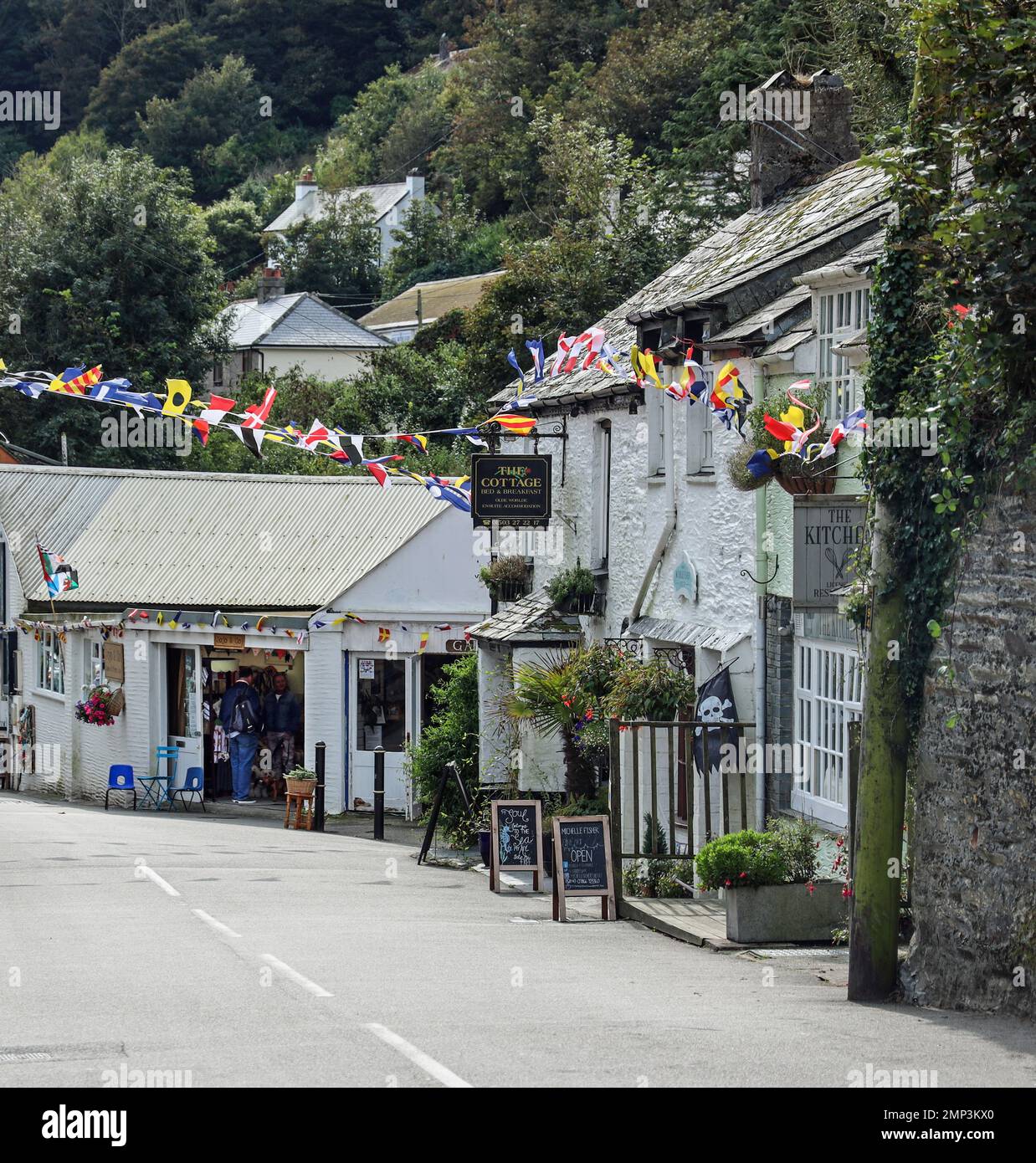 The picturesque Cornish village of Polperro. Bunting adds colour to a ...