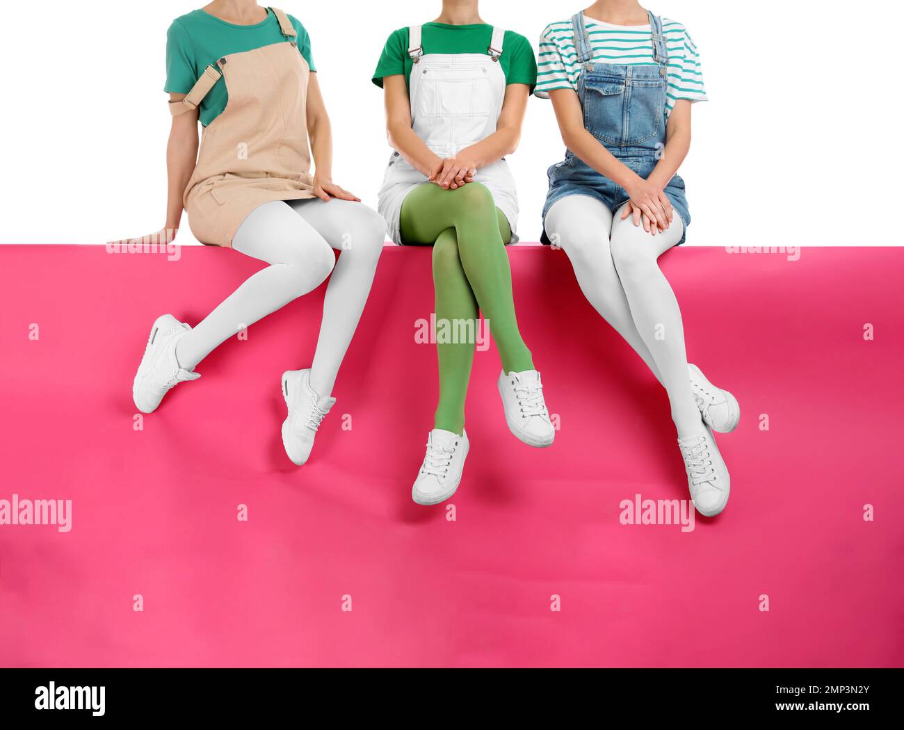 Group Of Women Wearing Colorful Tights And Stylish Shoes Sitting On Color Background Closeup