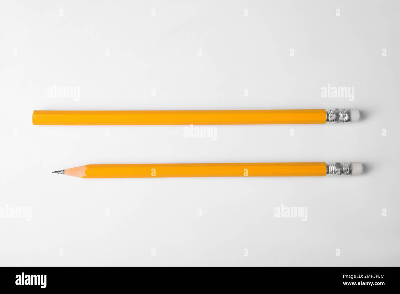 Pencil with point and unsharpened one on white background, top view ...