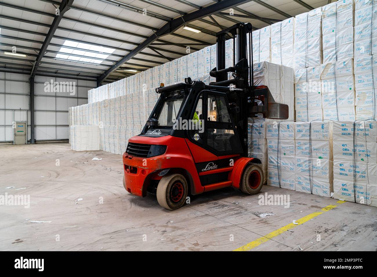 Forklift truck stacking paper bales in warehouse Stock Photo - Alamy