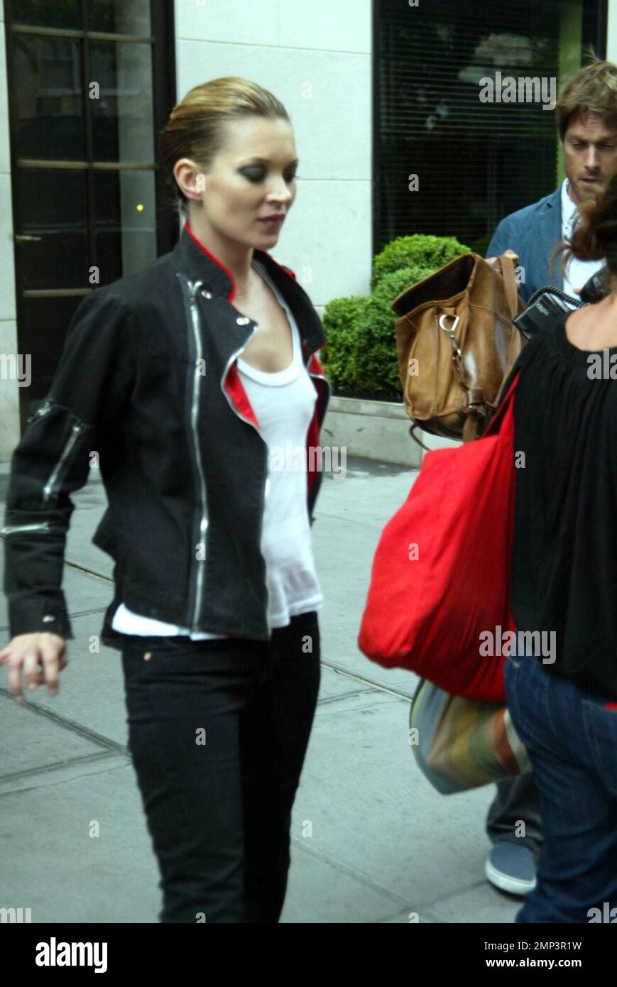 The seemingly bra-less Kate Moss wears a very revealing t-shirt as she ...