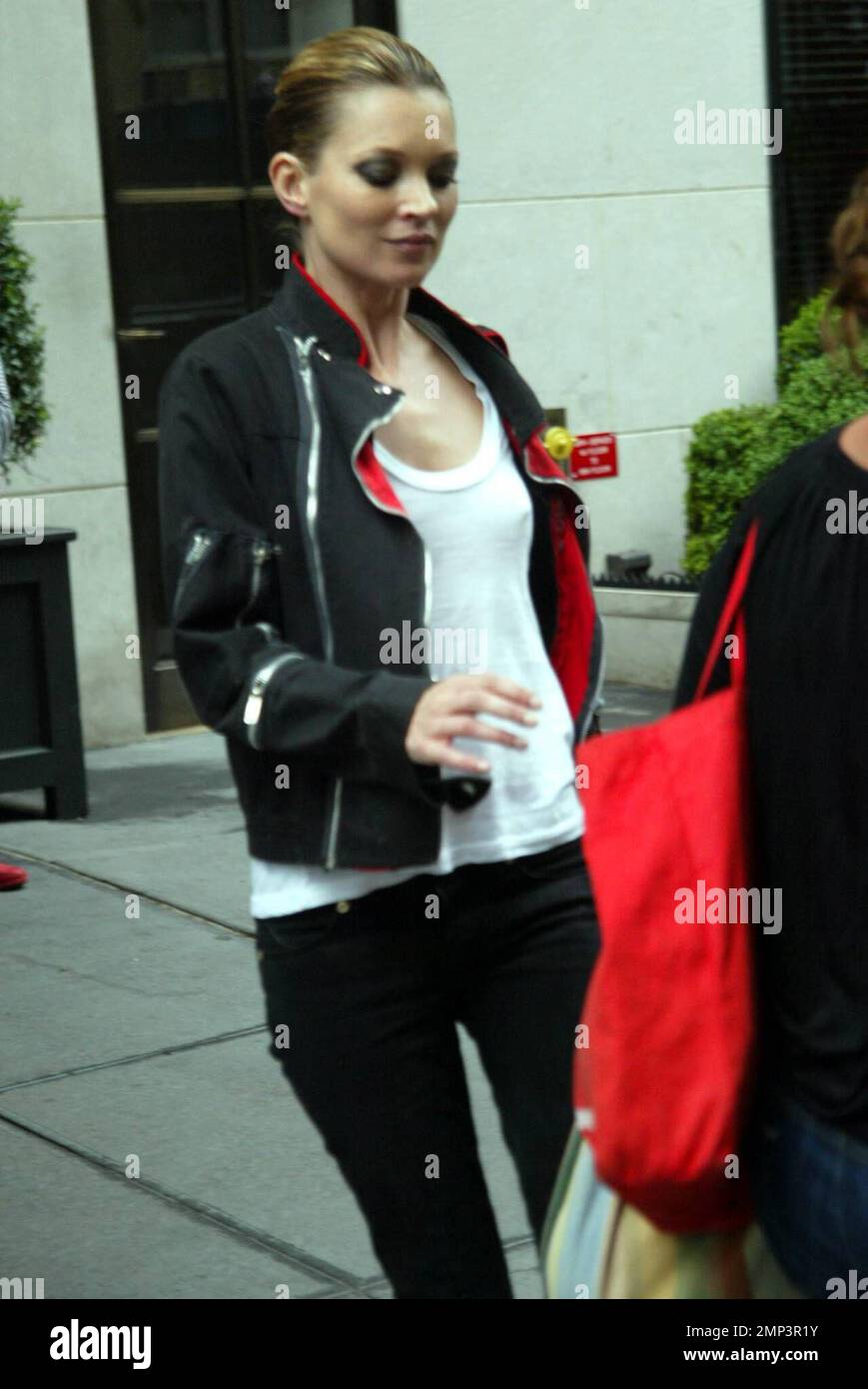 The seemingly bra-less Kate Moss wears a very revealing t-shirt as she ...