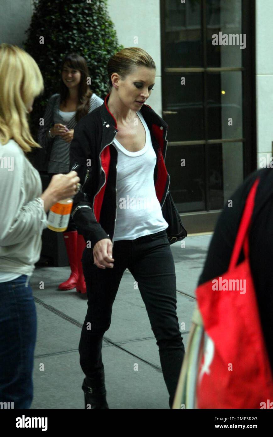 The seemingly bra-less Kate Moss wears a very revealing t-shirt as she ...