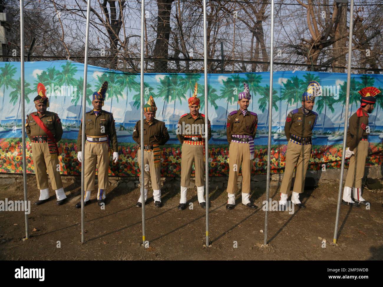 Indian paramilitary soldiers and policemen stand guard during a ...