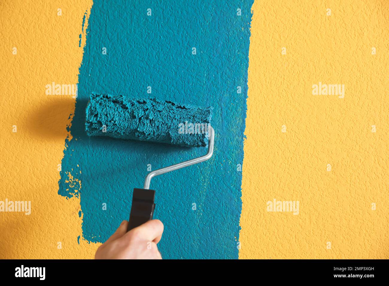 Man hand roller painting yellow hi-res stock photography and images - Alamy