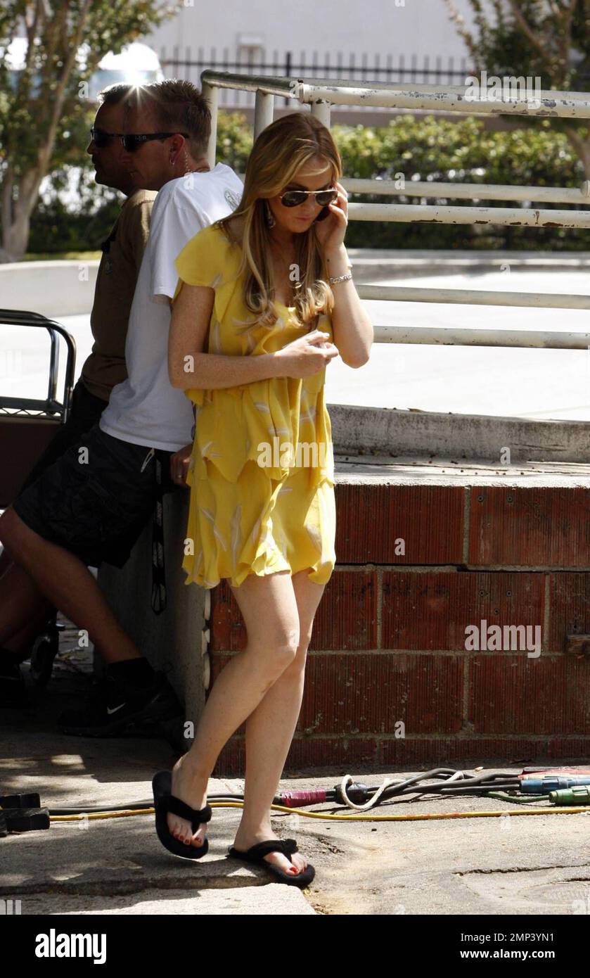 Lindsay Lohan talks on her cellphone while walking to a movie set in ...