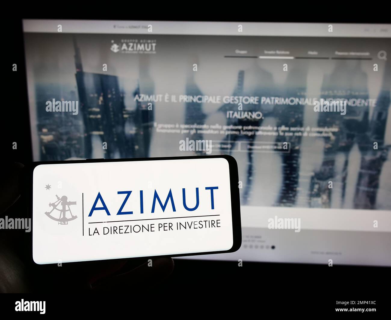 Person holding smartphone with logo of asset management company Azimut ...