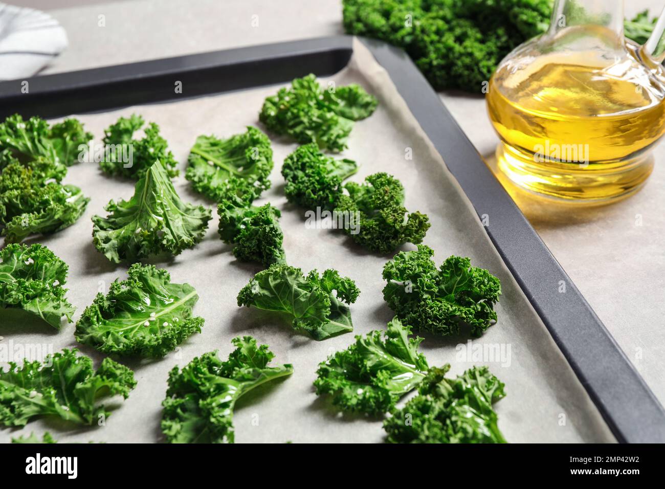 Raw cabbage leaves on baking sheet, closeup. Preparing kale chips Stock ...