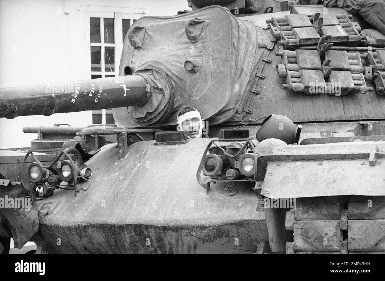 Wounded U.S. Marine tank driver looks out from under his tank's 90 mm ...