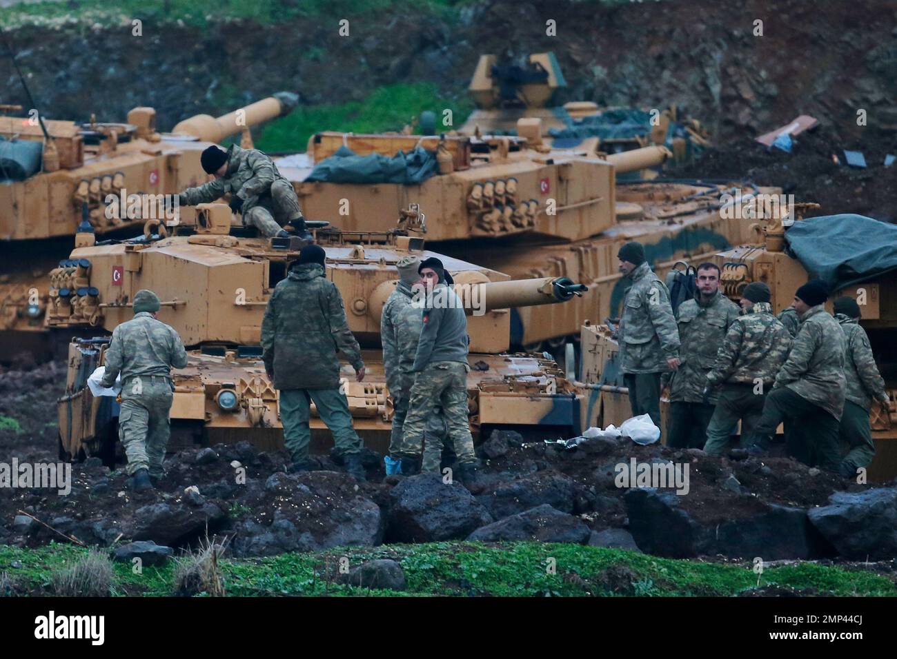 Turkish soldiers prepare their tanks to enter combat and join a ...