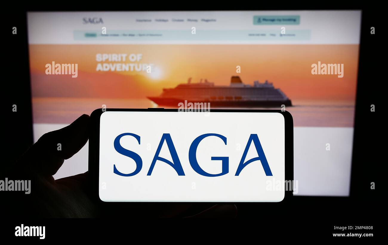 Person holding smartphone with logo of travel and financial services ...