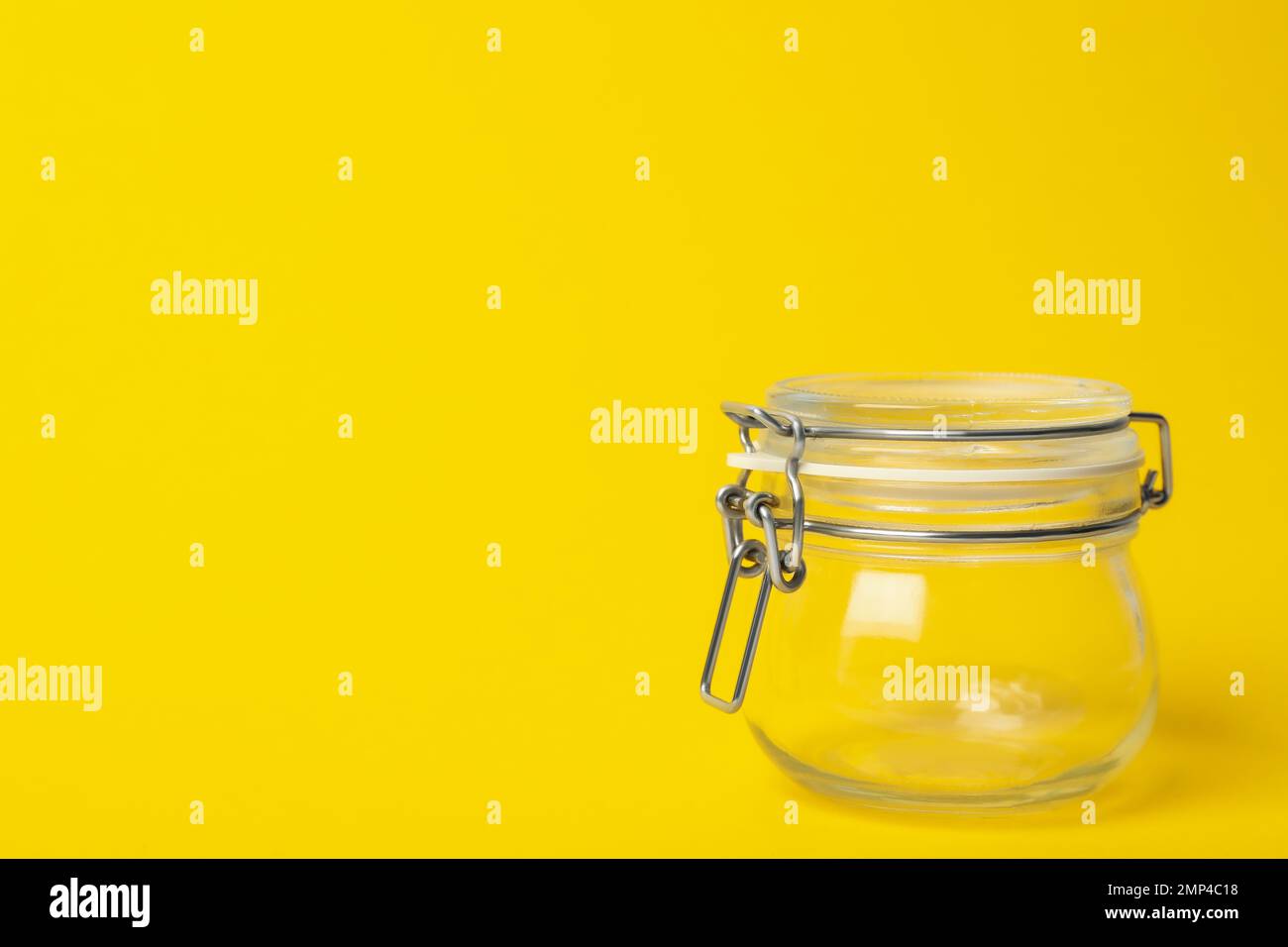 Closed empty glass jar on yellow background, space for text Stock Photo ...
