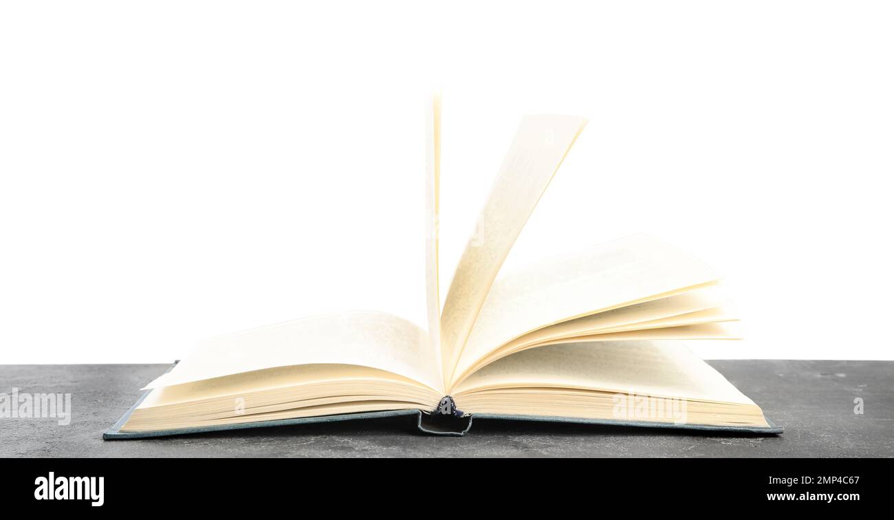 Open book on grey stone table against white background Stock Photo - Alamy