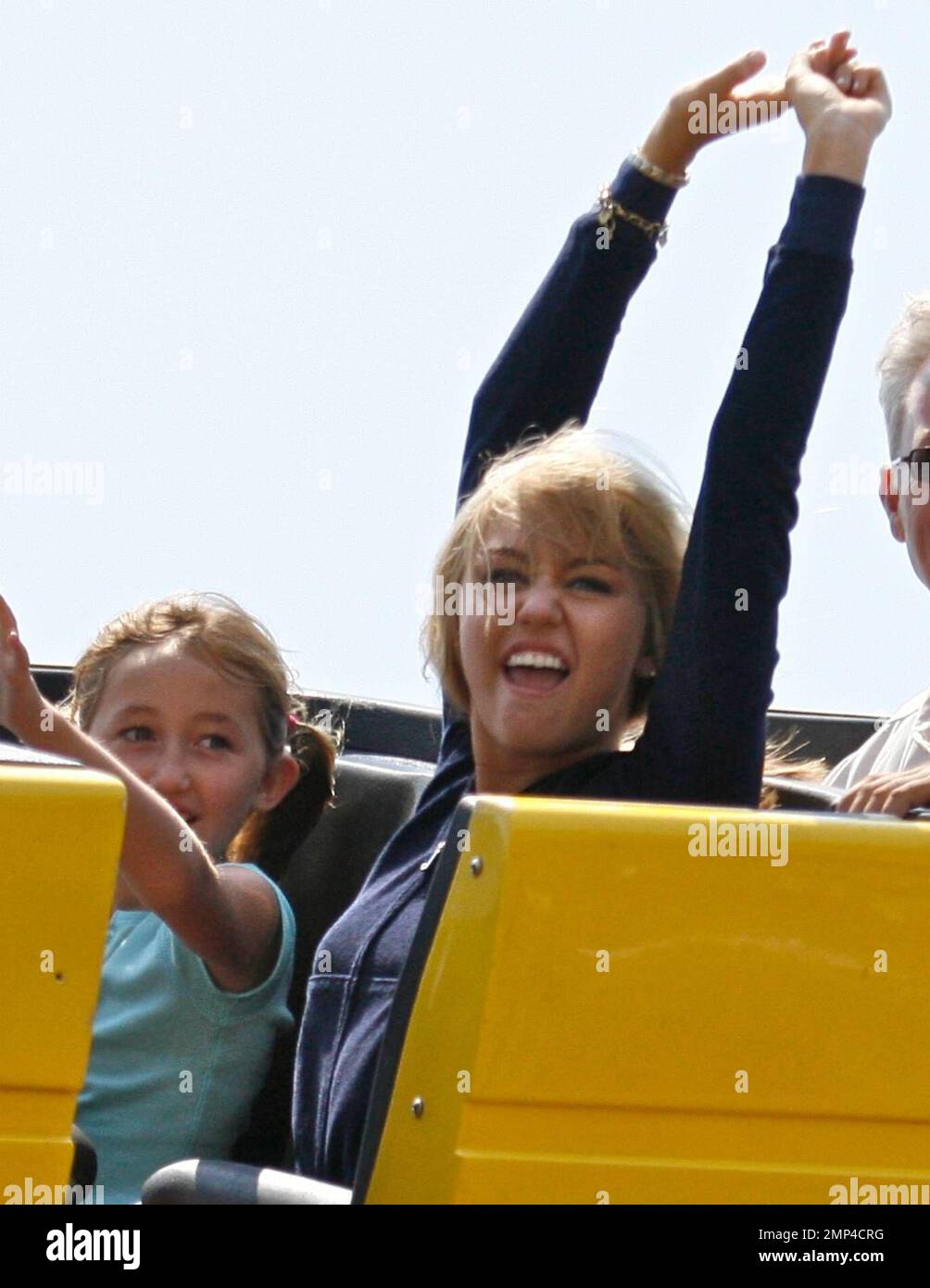Miley Cyrus has fun on the rides with her sister (check) at the Santa ...