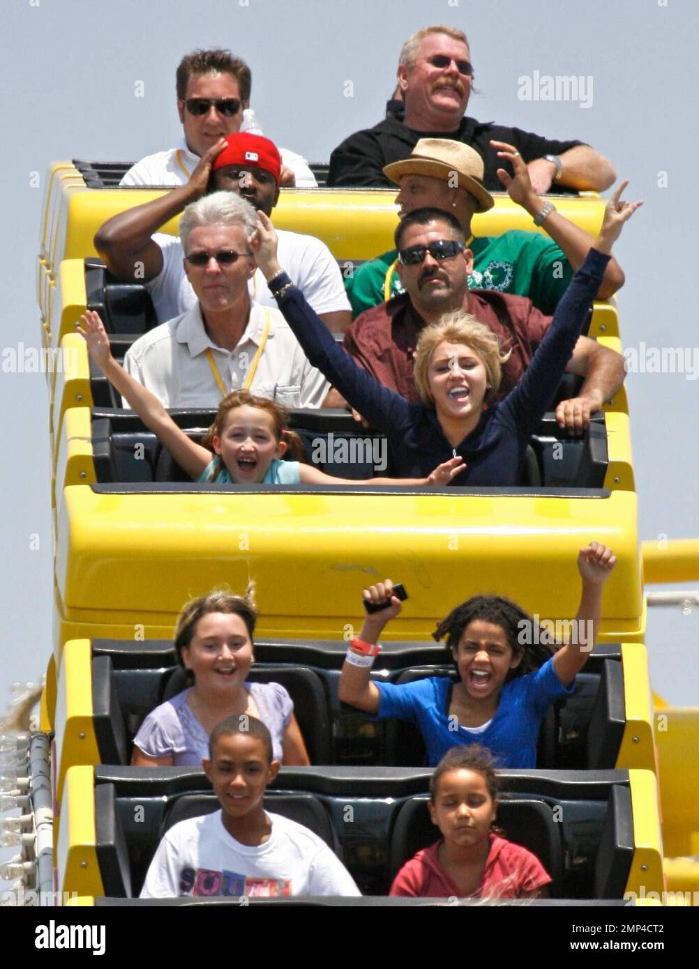 Miley Cyrus has fun on the rides with her sister (check) at the Santa ...