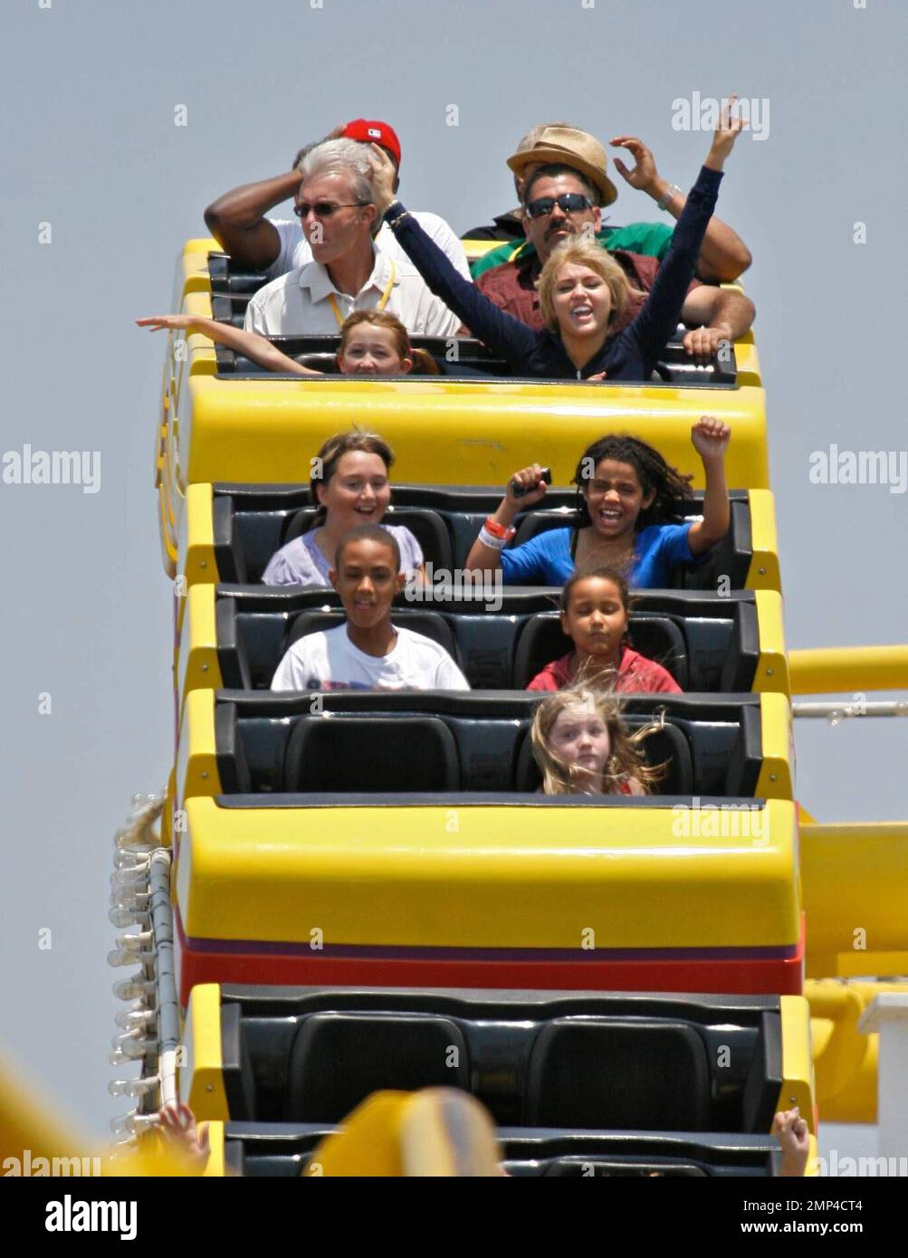 Miley Cyrus has fun on the rides with her sister (check) at the Santa ...