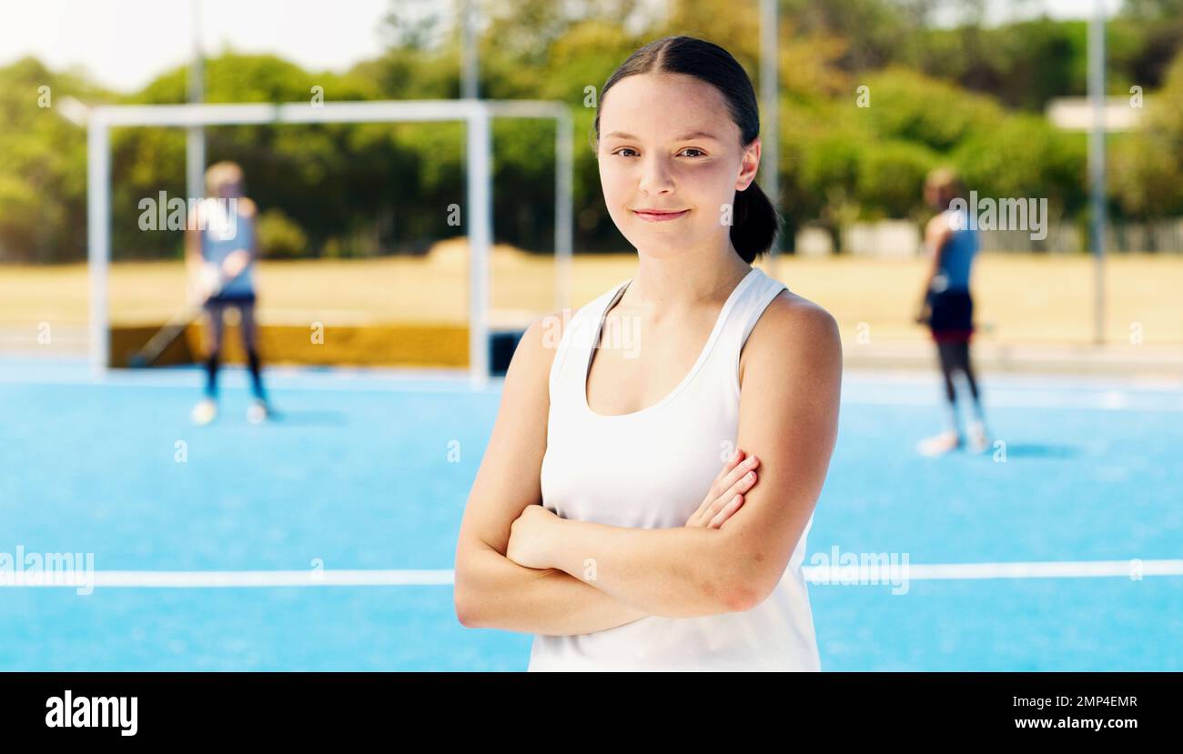 Portrait, hockey girl and smile on field with focus, goal or vision at ...