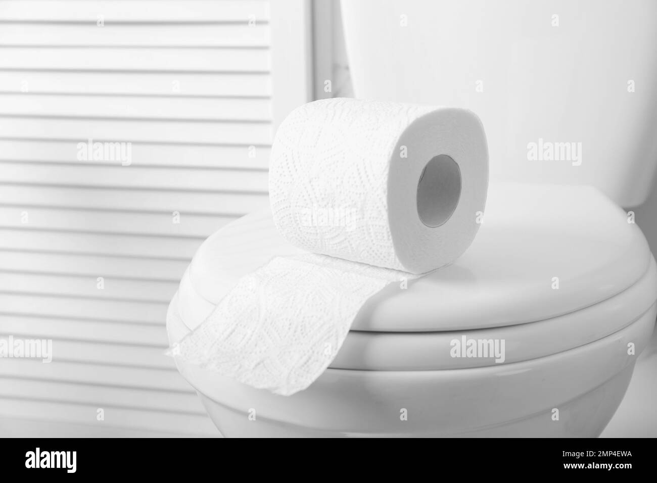 New paper roll on toilet bowl in bathroom Stock Photo - Alamy