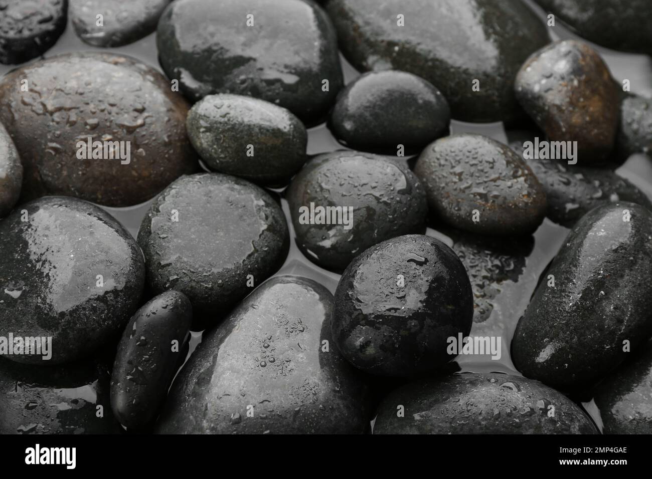 Spa stones in water as background, closeup. Zen lifestyle Stock Photo ...