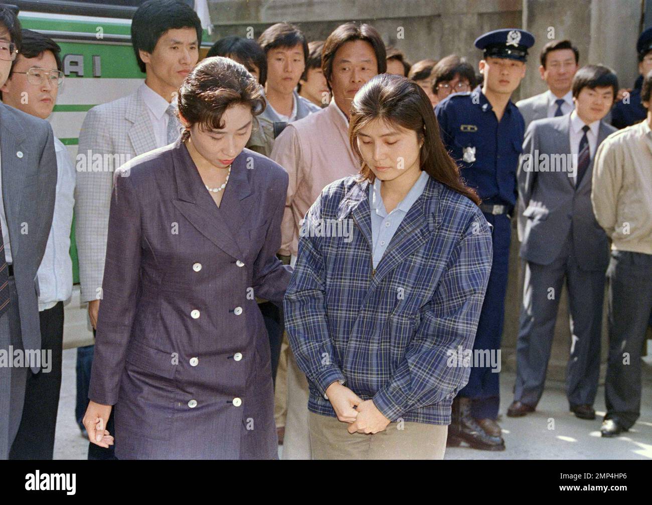 Confessed North Korean agent Kim Hyon-hui, right, enters the high court ...