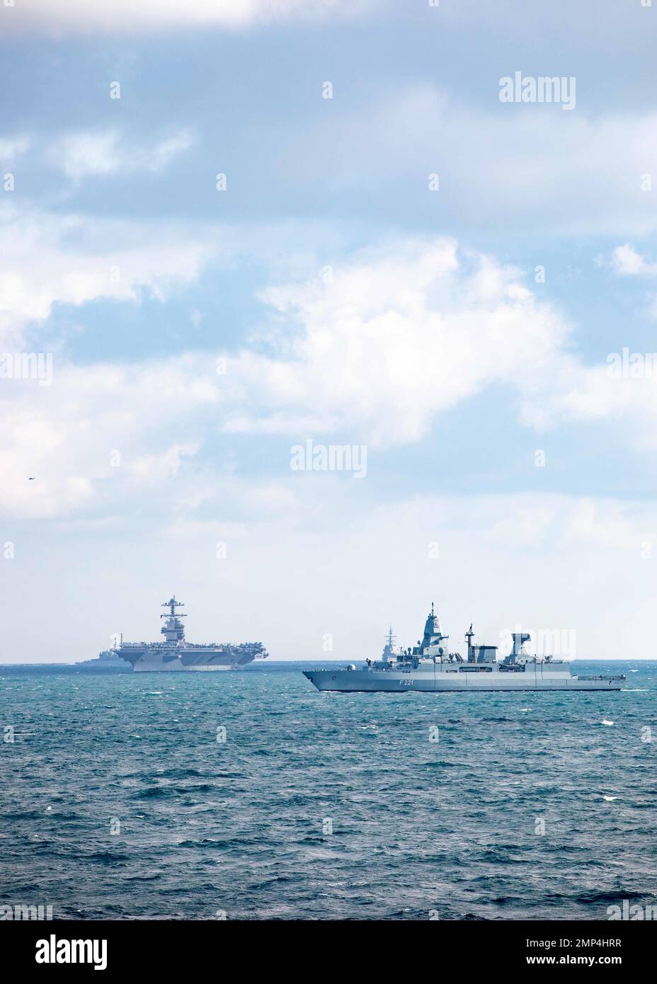 The German Sachsen-class frigate FGS Hessen (F221), foreground, steams ...