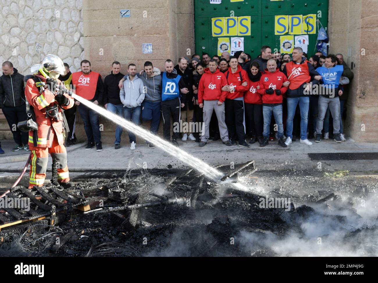 A fireman puts out a fire of wooden pallets and tyres as penitentiary ...