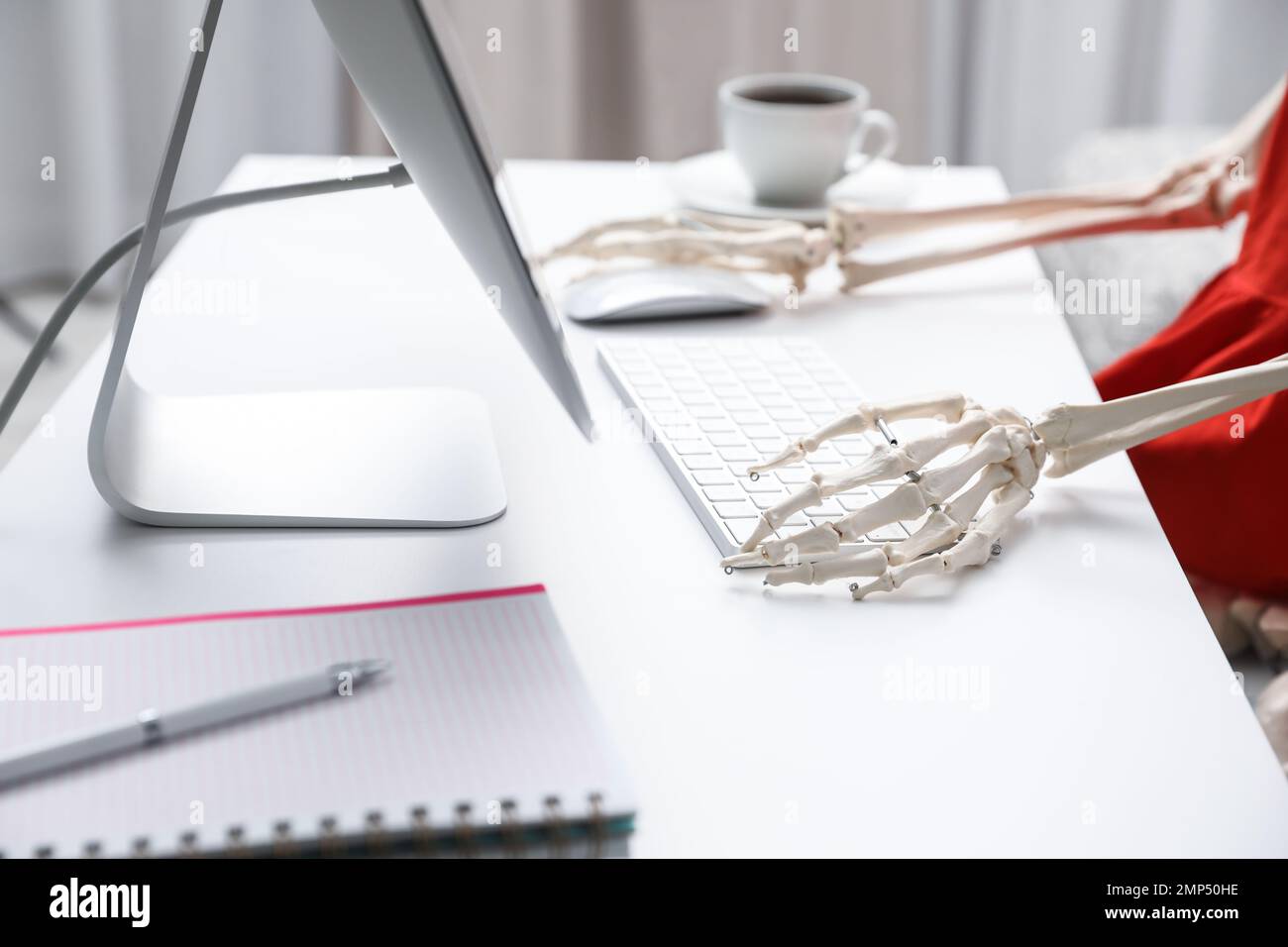Human skeleton at table in office, closeup Stock Photo - Alamy