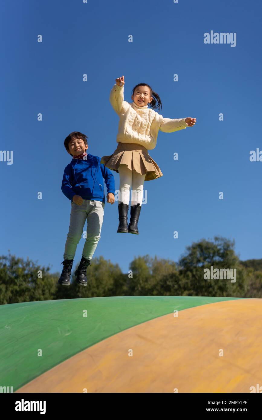 Happy children jumping Stock Photo - Alamy