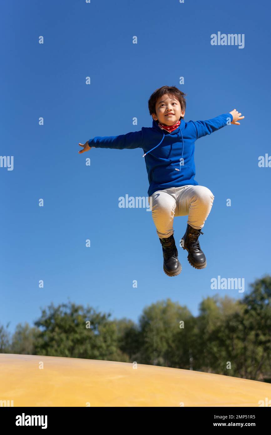 Happy boy jumps Stock Photo - Alamy