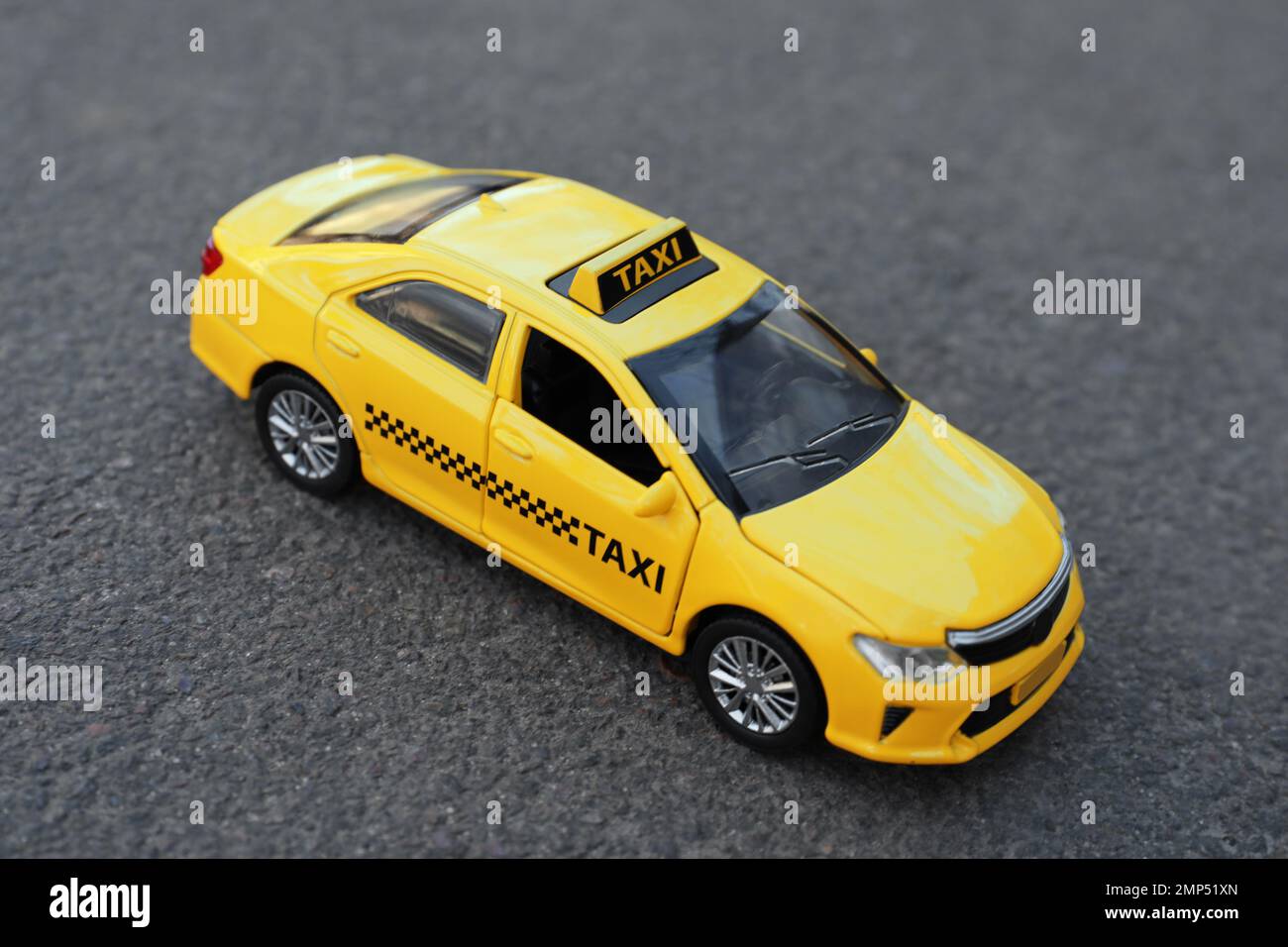 Yellow taxi car model on city street Stock Photo - Alamy
