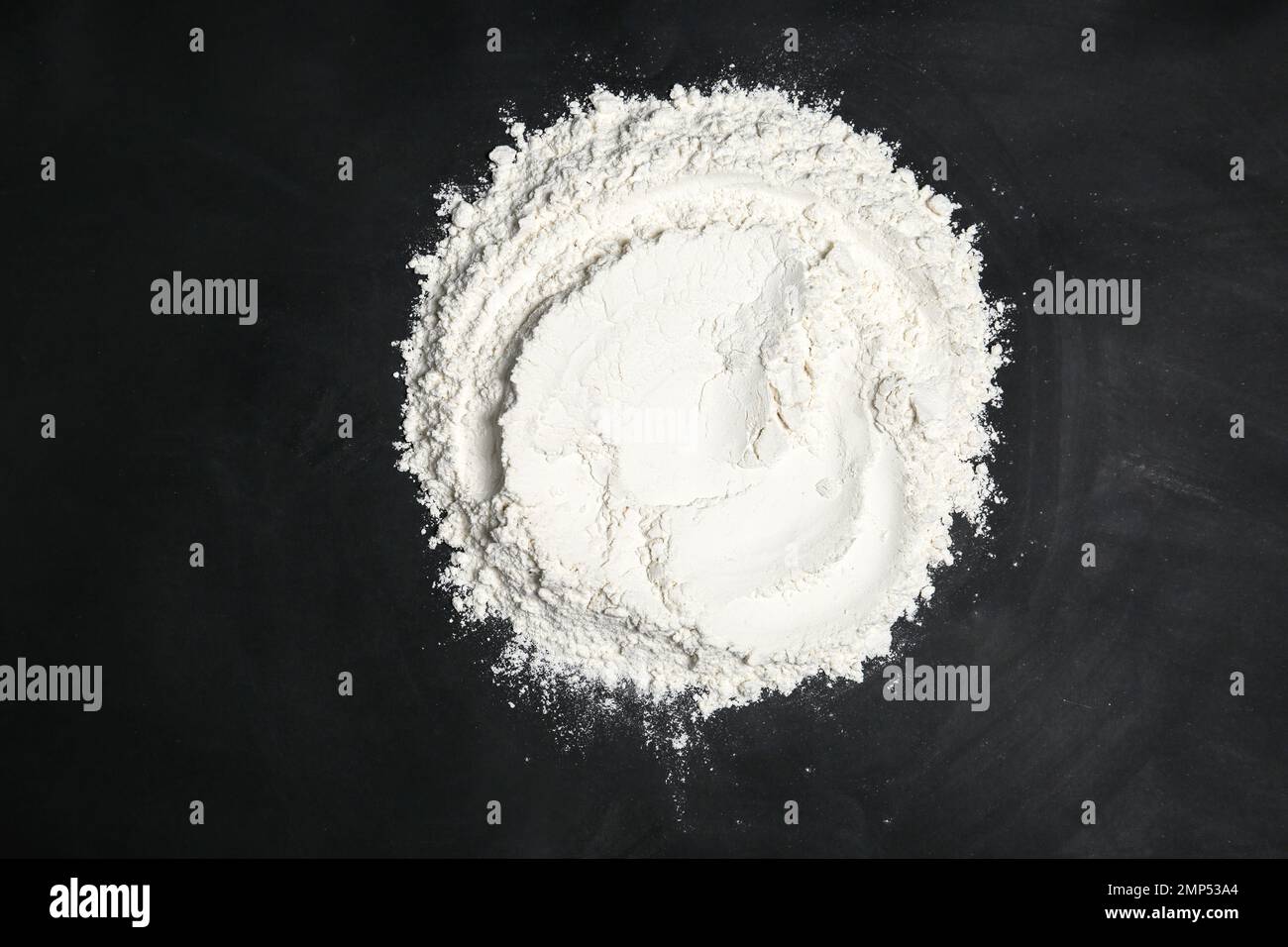 Pile of flour on black table, top view Stock Photo - Alamy