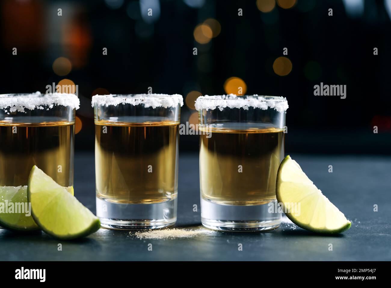 Mexican Tequila shots, lime slices and salt on bar counter Stock Photo ...