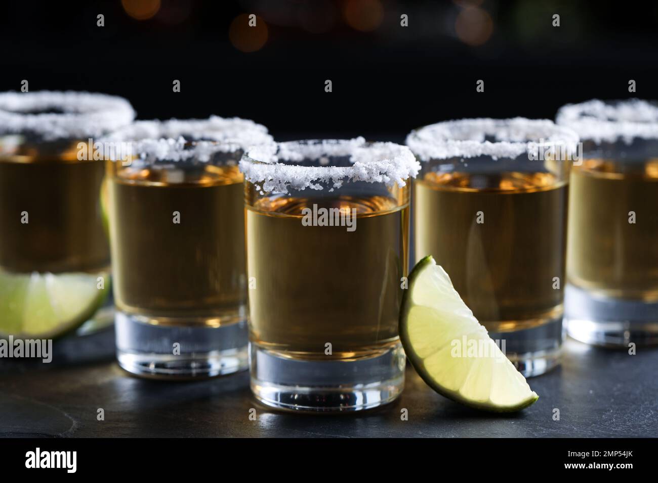 Mexican Tequila shots, lime slices and salt on bar counter Stock Photo ...