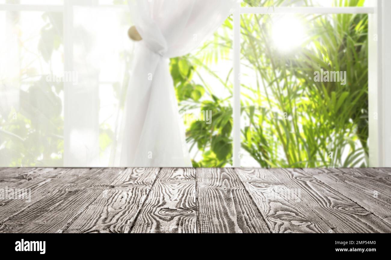 Empty wooden table in front of window. Sunny morning Stock Photo - Alamy