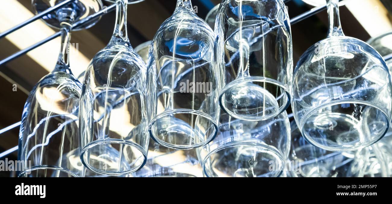 clean wine glasses hang over the bar. Glass, utensils, objects Stock ...