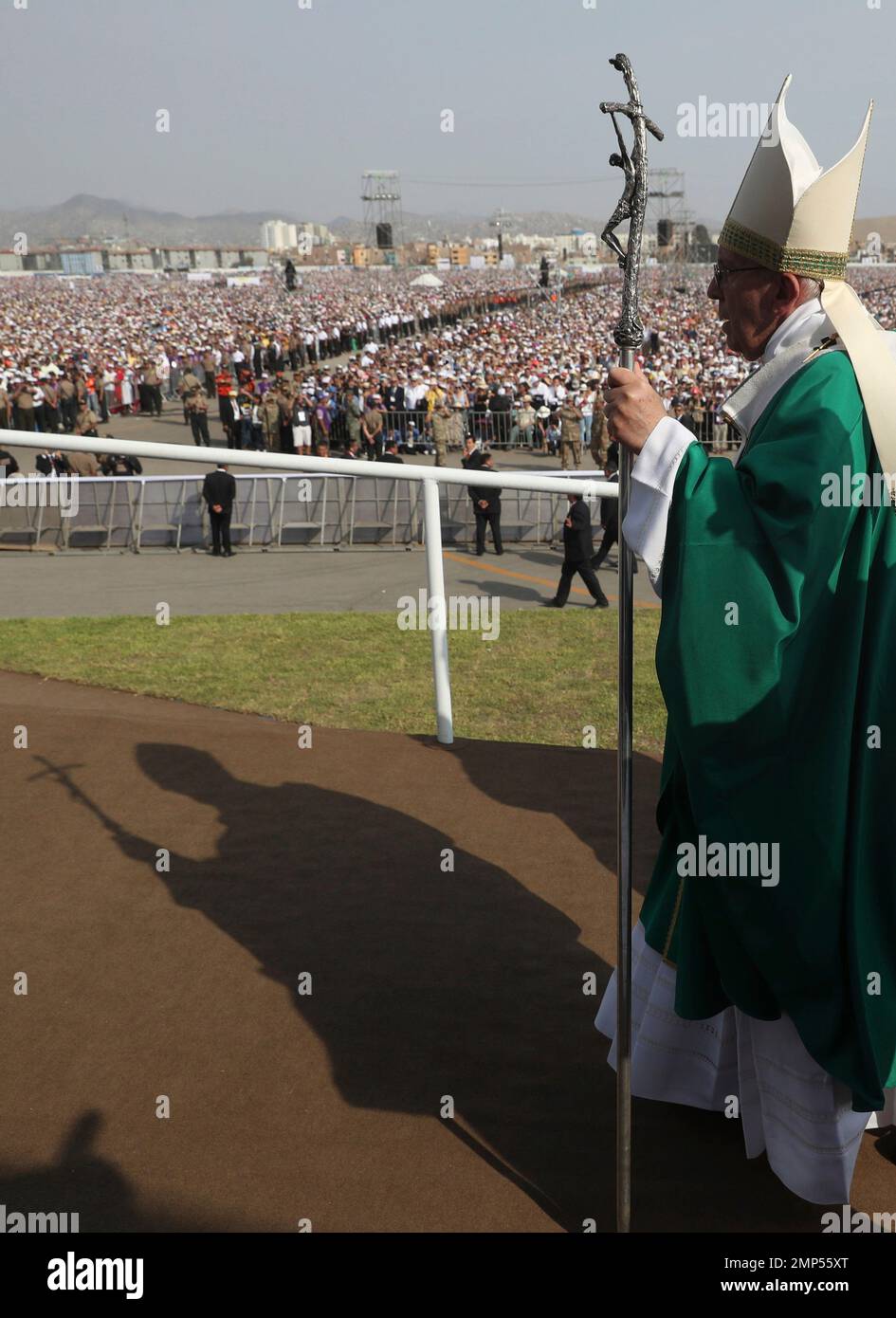 Pope Francis' shadow is cast as he arrives on the altar to celebrate ...
