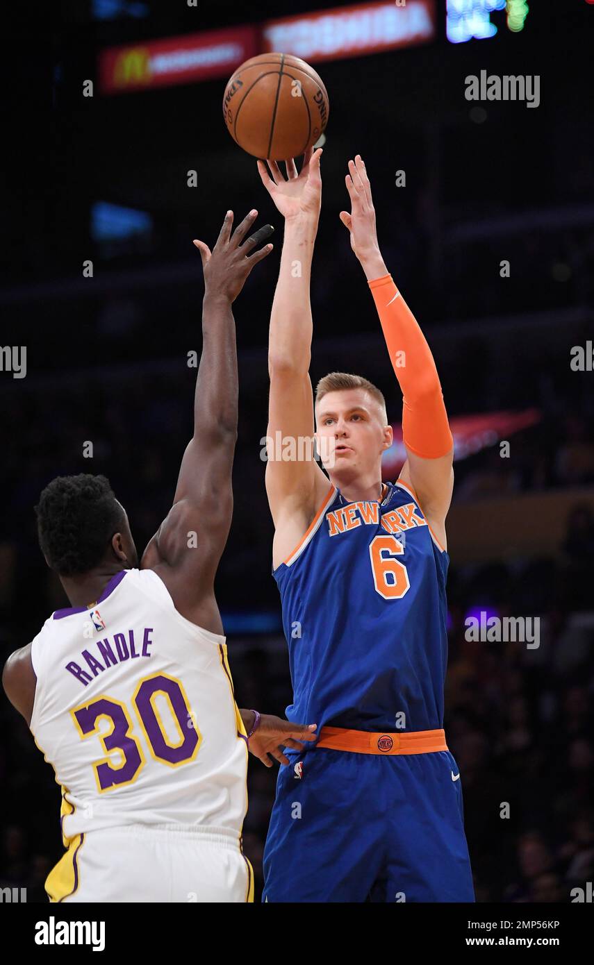 New York Knicks forward Kristaps Porzingis, right, of Latvia, shoots as ...
