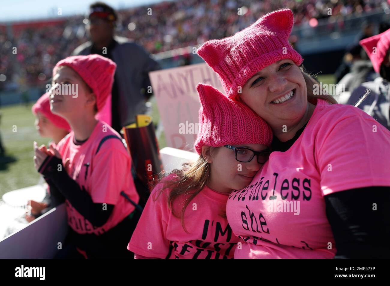 Eight-year-old Zoe Rodis leans on her mother Jennifer Rodis, right ...