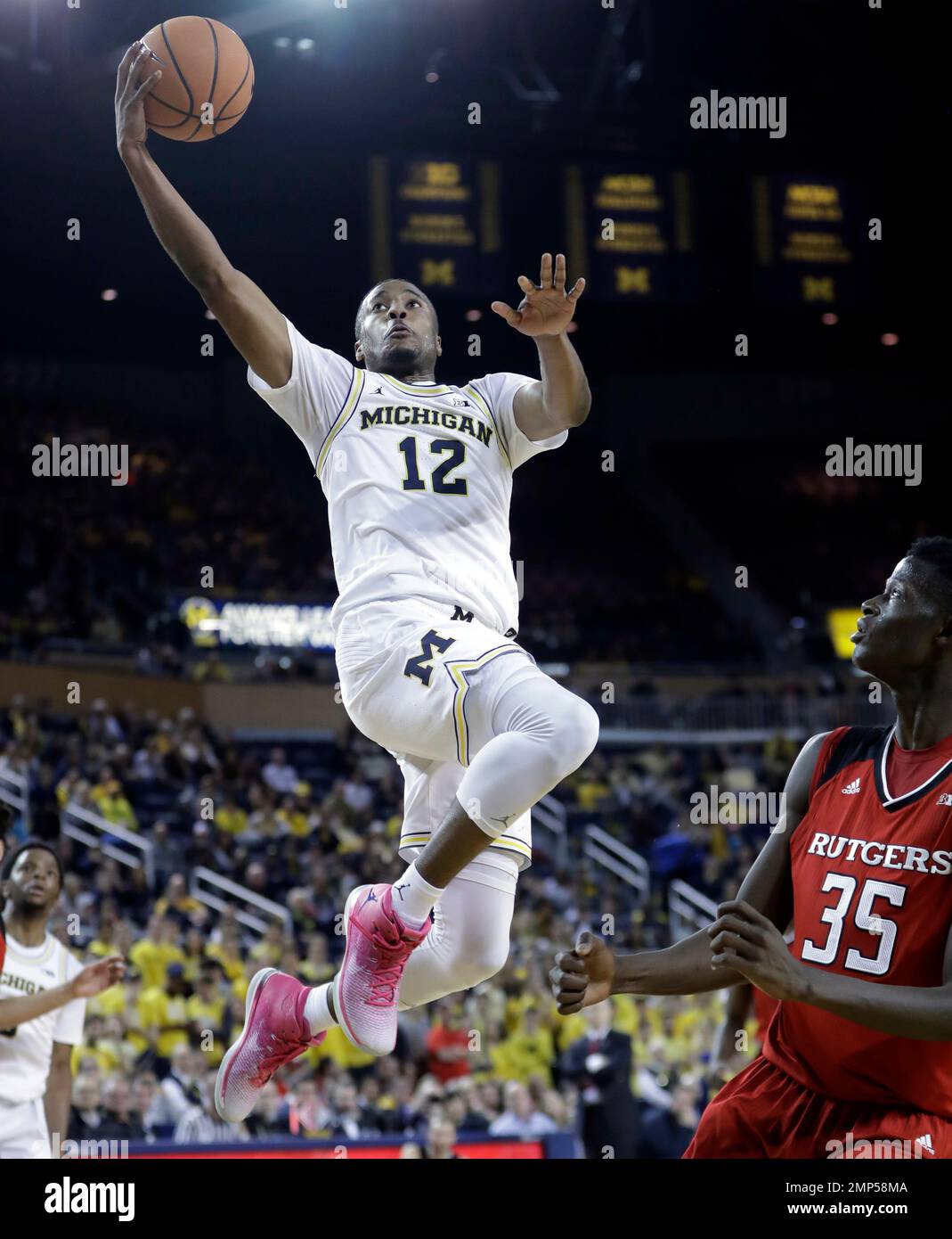 Michigan guard Muhammad-Ali Abdur-Rahkman (12) makes a layup as Rutgers ...