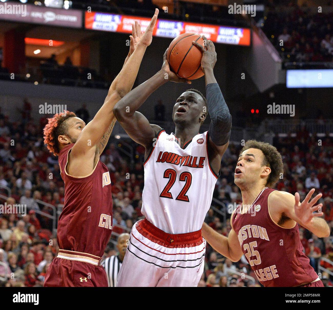 Louisville forward Deng Adel (22) puts up a shot between the defense of ...