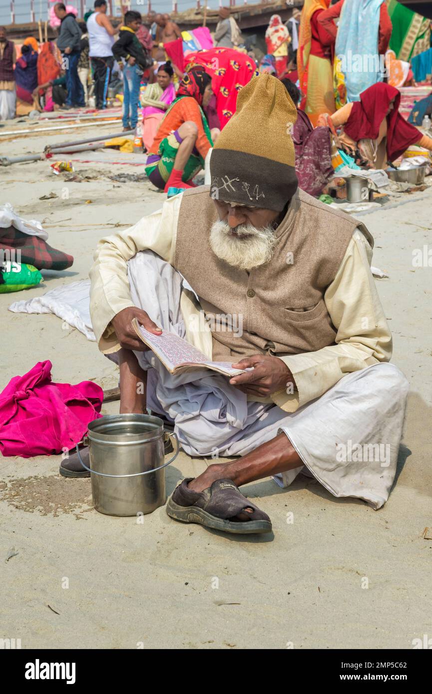 Pilgrim reading holy text, Allahabad Kumbh Mela, World’s largest ...