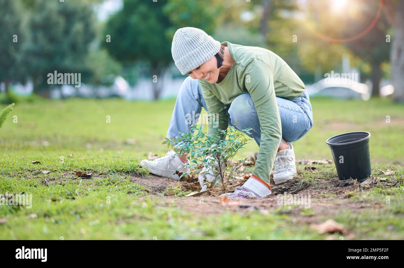 Plant, nature and eco friendly woman gardening in a park for ...